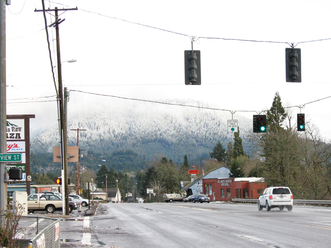 A quiet morning in Oakridge, where misty, snow-capped peaks rise behind small-town streets&mdash;a gateway to adventure in the Cascades.