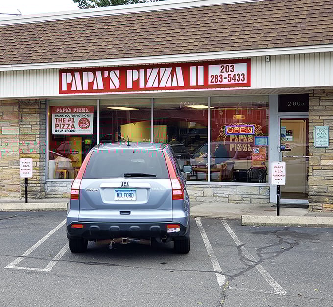 That simple red sign has been calling Milford pizza lovers home for generations of cheesy goodness.