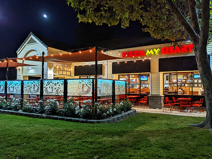 Where surf culture meets pizza perfection. Pizza My Heart's evening patio glows with string lights and satisfied customers.