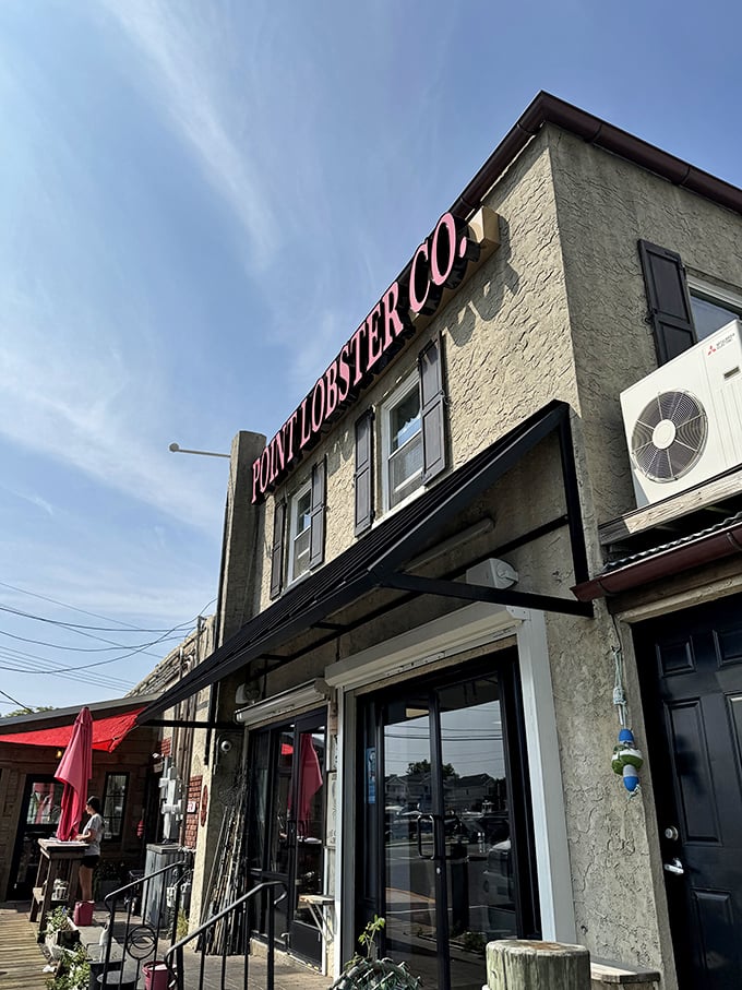 Reaching for the sky and seafood perfection! Point Lobster's pink signage pops against the blue heavens like a delicious promise written in the clouds.