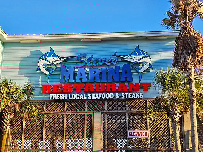 That lattice work and palm trees frame the entrance perfectly, welcoming you to fresh catches and marina views that never get old.