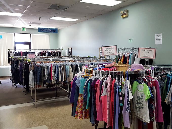 Neatly organized racks of colorful possibilities. Each hanger holds someone's next favorite outfit waiting to be discovered!