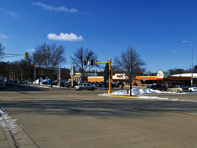 Snow dusts this intersection like powdered sugar, while the Subway sign promises familiar comfort in unfamiliar territory.