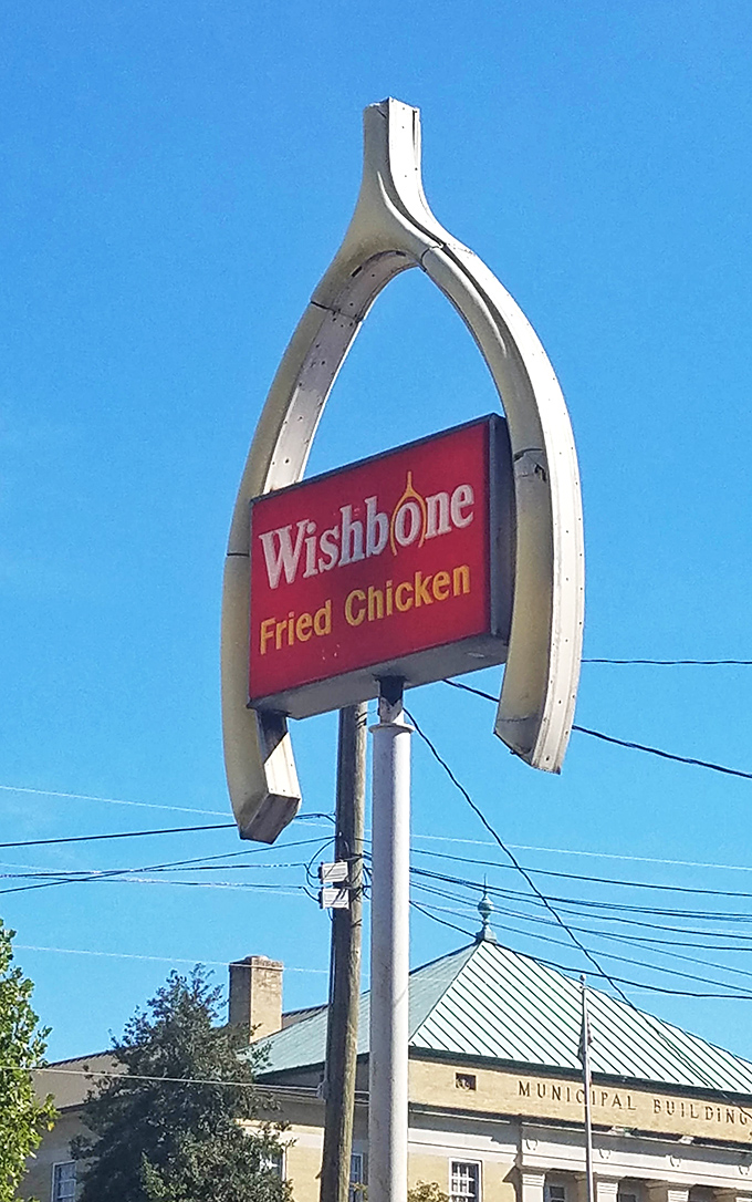 The iconic wishbone-shaped sign reaches skyward like a chicken lover's dream. Structural whimsy that perfectly matches the joy their fried chicken delivers.