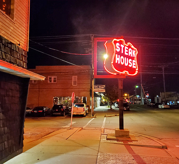 That classic neon "Steak House" sign glows like a promise of perfectly grilled beef ahead.