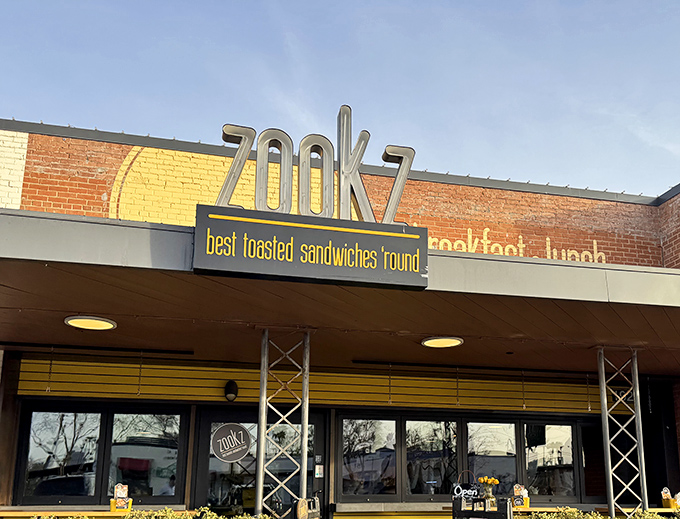 Cheerful flowers frame outdoor seating where you can enjoy your sandwich while watching the world go by contentedly.