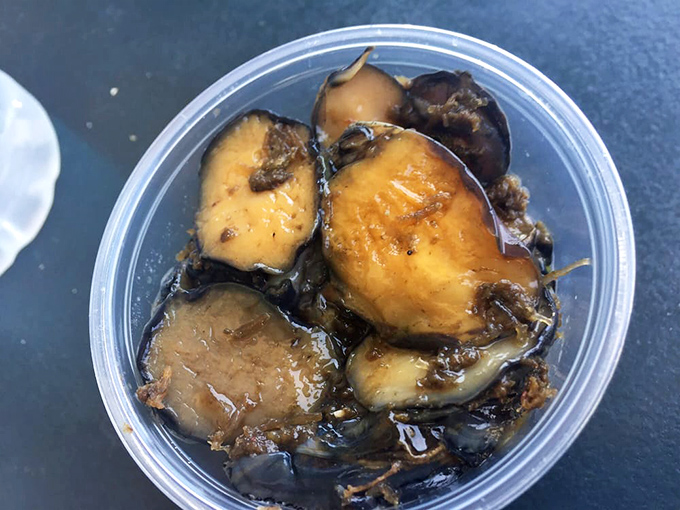 These glistening abalone pieces swim in savory sauce. A delicacy that tastes like the ocean distilled into tender, umami-rich morsels.