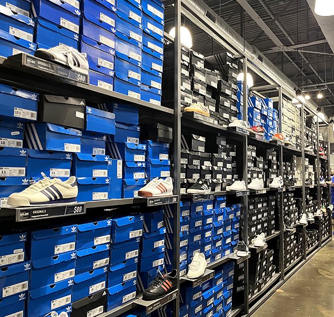 The Adidas outlet's wall of blue boxes holds footwear dreams at dream prices. Sneakerheads, prepare your credit cards accordingly.