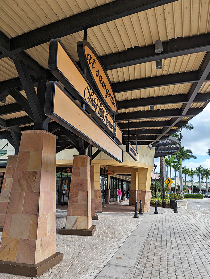 Directional signs hover overhead like retail constellations, guiding bargain hunters through this shopper's paradise with celestial precision.