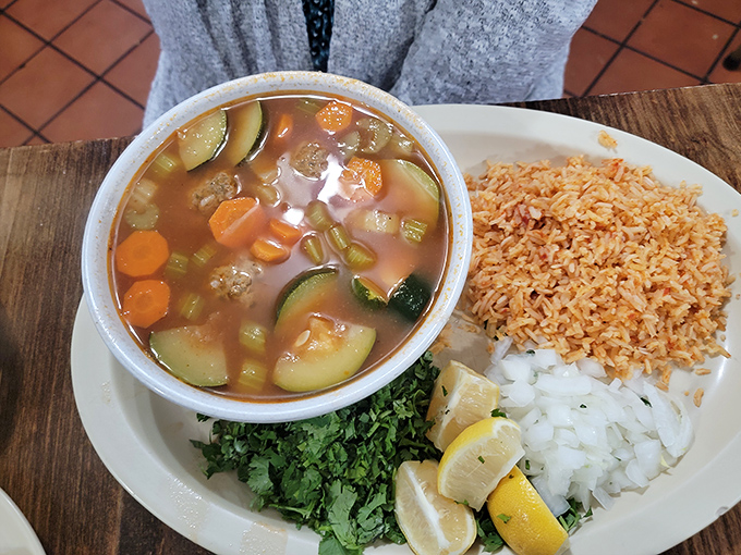 Albondigas soup with all the fixings – proof that someone's grandmother is in that kitchen, wielding spices like a culinary sorceress.