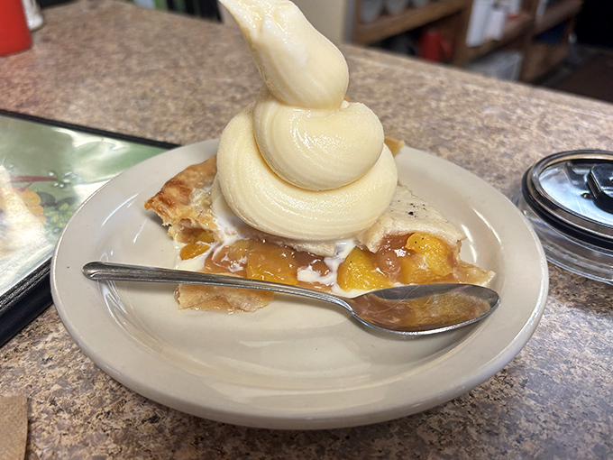 Apple pie &agrave; la mode with ice cream piled high like a mountain of vanilla dreams &ndash; proof that sometimes the classics really are unbeatable.