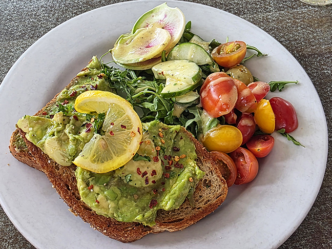 Avocado toast that would make millennials sell their houseplants to afford it, brightened with watermelon radish and heirloom tomatoes that taste like summer.