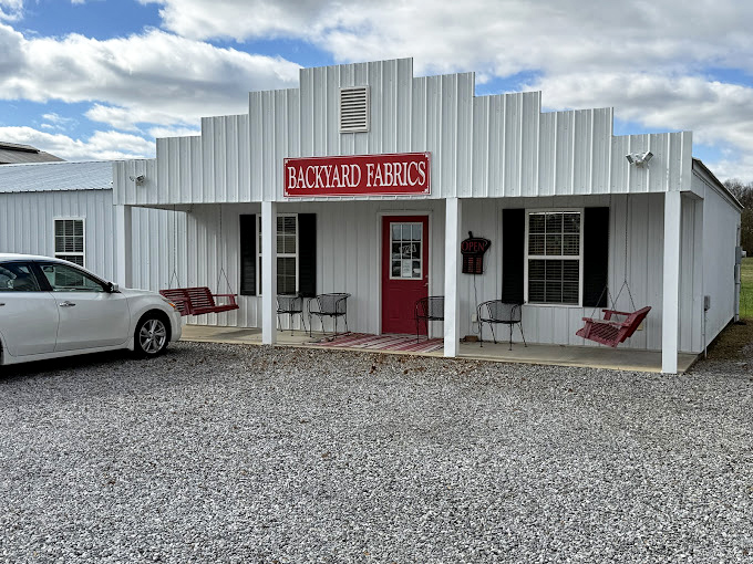 Backyard Fabrics offers crafters a treasure trove of materials without big-box markup. The welcoming porch invites neighbors to sit and chat—a social amenity that costs nothing.