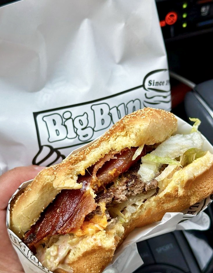 That cross-section reveals the geological layers of burger perfection—the bacon stratum is particularly impressive to culinary archaeologists everywhere.