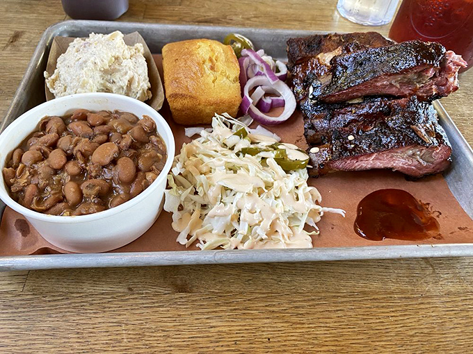 That smoke ring on the ribs is like nature's neon sign announcing: "This is the real deal, folks." The beans aren't slouching either.