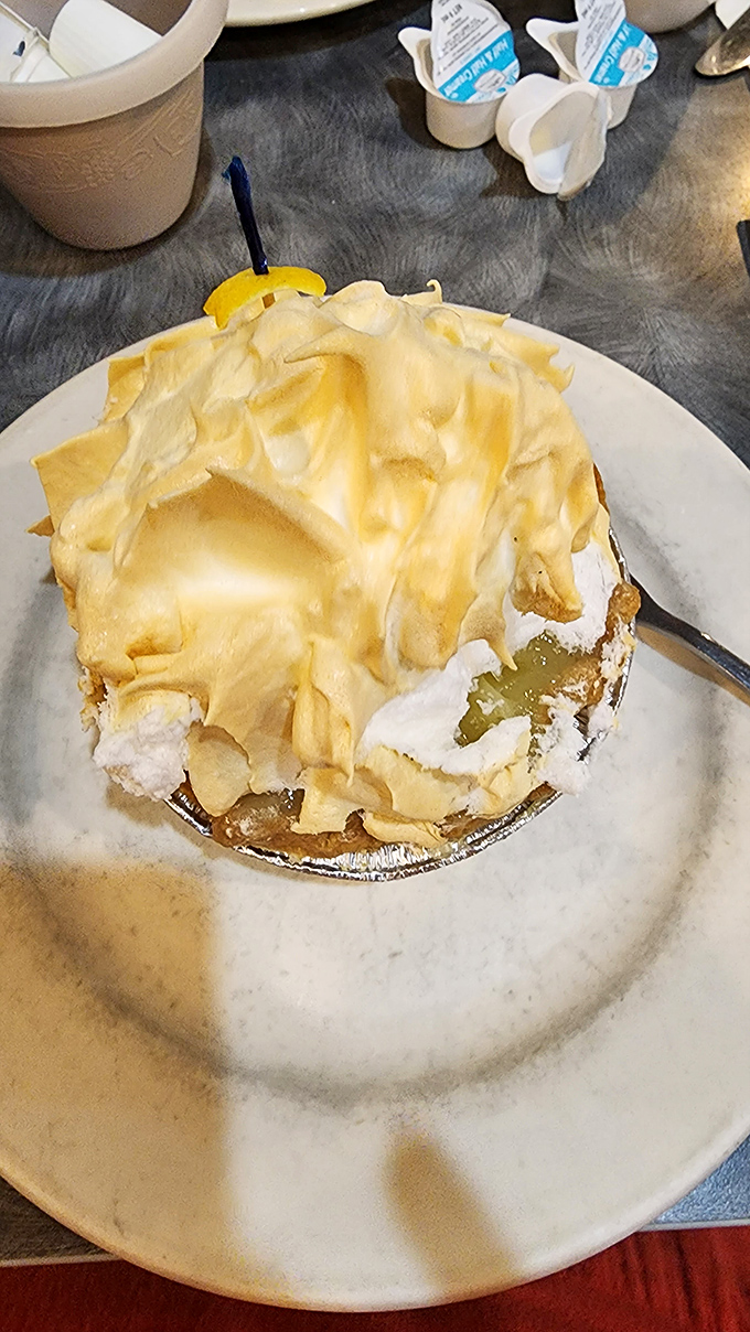Banana meringue pie wearing a cloud-like hat that's taller than your expectations. Dessert dreams come true.