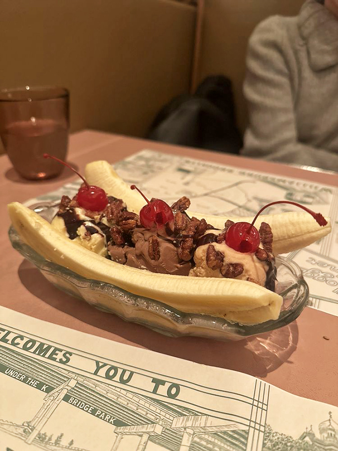 This banana split isn't just dessert, it's architectural brilliance&mdash;a split banana cradles ice cream topped with chocolate sauce, nuts, and those essential cherries.