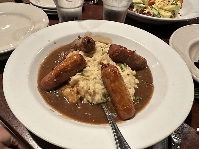 Bangers and Mash &ndash; where plump sausages lounge on creamy potato islands in a sea of savory gravy. Comfort food that hugs you from the inside out.