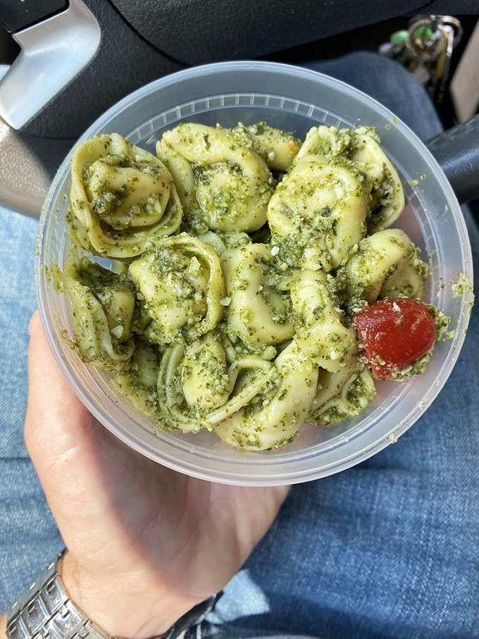 Pesto tortellini that looks like little green jewels, each pasta pocket a tiny treasure chest of flavor that makes eating from a plastic container feel surprisingly sophisticated.