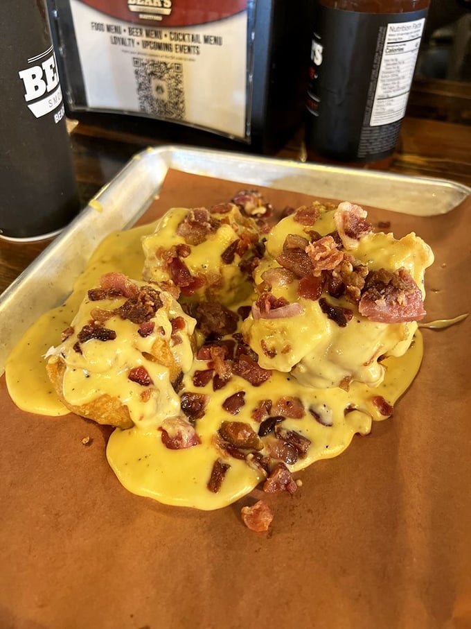 Potatoes achieving their highest purpose—smothered in cheese sauce and crowned with bacon bits like edible confetti.