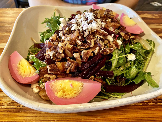 This beet and goat cheese salad proves vegetables can party too, with pickled eggs joining the colorful celebration.