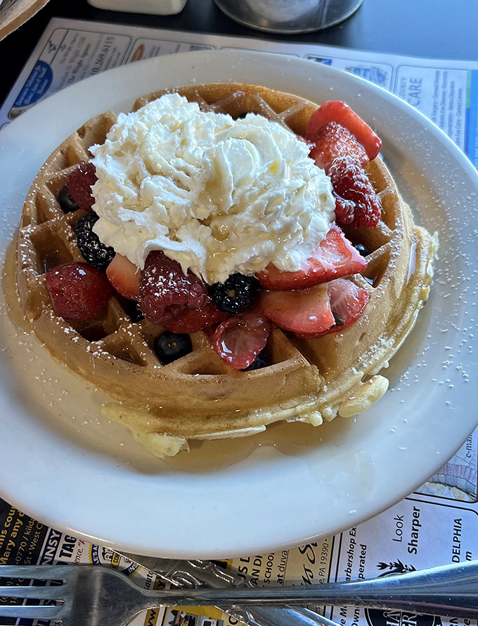 A waffle wearing a crown of fresh berries and whipped cream—breakfast royalty that demands your full attention.