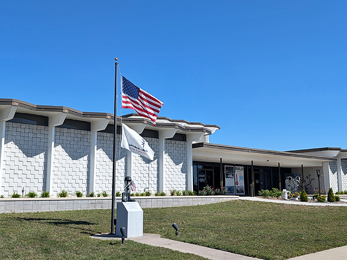 The Besser Museum stands proudly under blue skies, its clean white lines housing collections that tell northeastern Michigan's story from prehistoric fossils to folk art.
