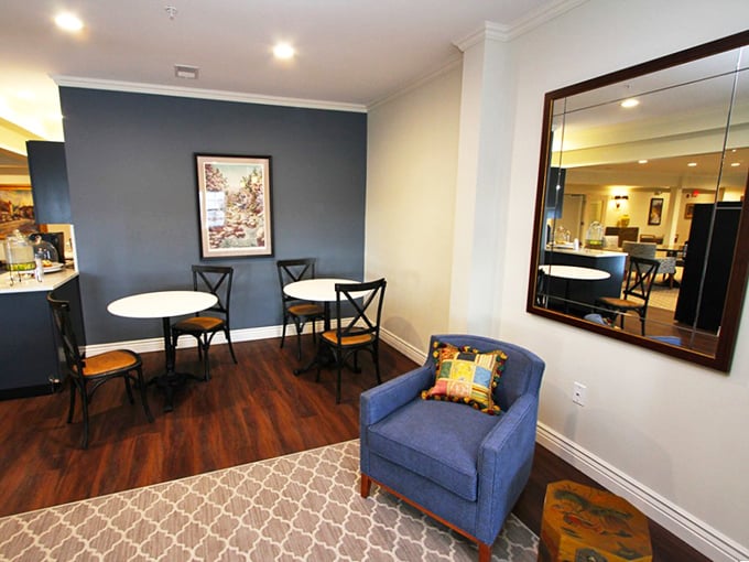 A cozy bistro corner perfect for morning coffee, afternoon chess, or plotting which activity to conquer next. Retirement multitasking at its best.