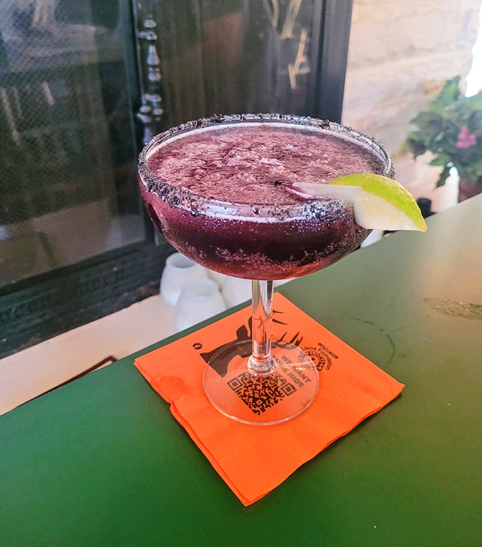 The blueberry margarita's vibrant purple hue and sugar-rimmed glass promise a sweet-tart flavor adventure that delivers with every sip.