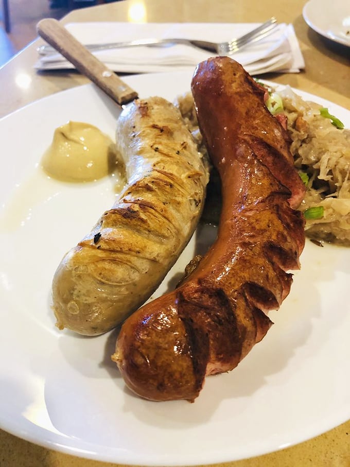 Two kinds of wurst living in harmony with sauerkraut, like a delicious United Nations on your plate.