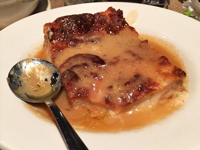 Bread pudding swimming in rum sauce that could make a dessert skeptic weep with joy. Comfort food that hugs your soul.