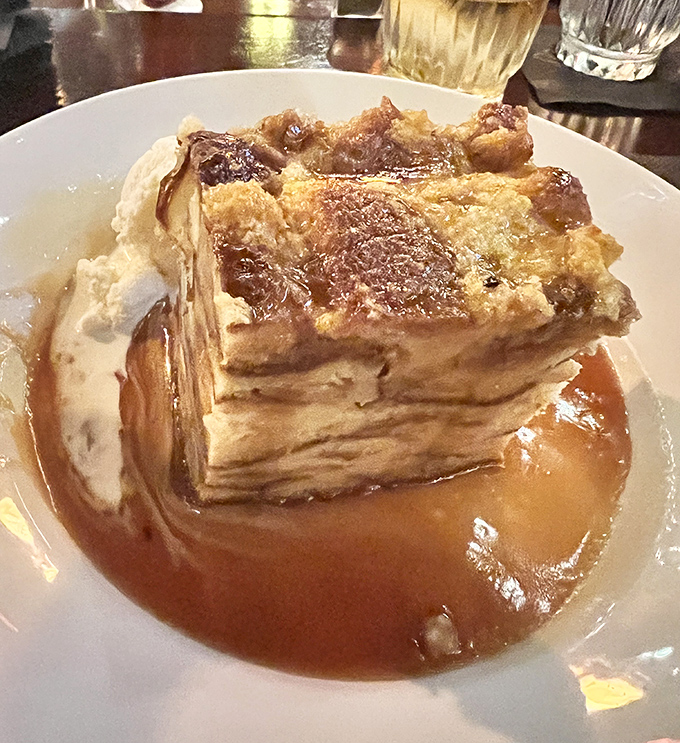 Bread pudding that would make angels weep. Layers of custard-soaked goodness swimming in a caramel sea that demands to be savored slowly.