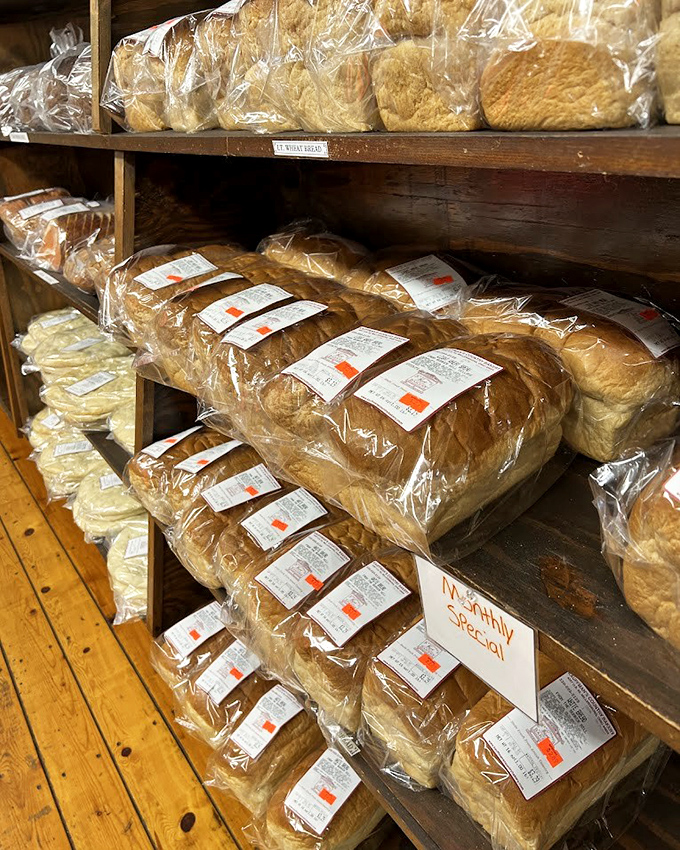 Bread loaves stacked like gold bars in a carbohydrate Fort Knox. Each one promises sandwiches that will ruin store-bought bread for you forever.