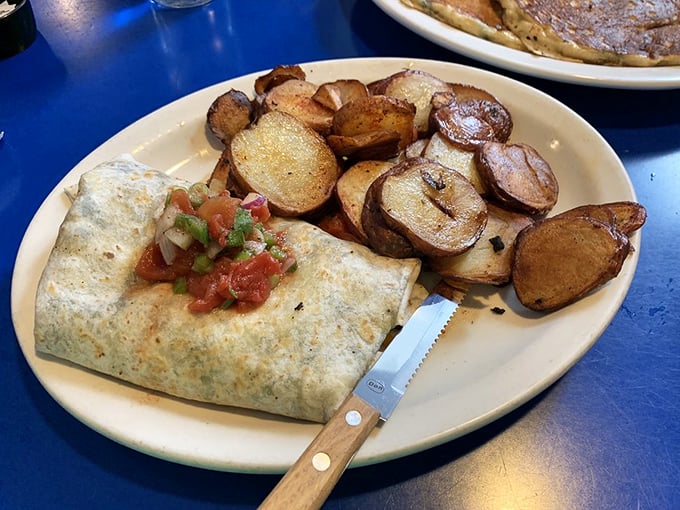 A breakfast burrito so perfectly wrapped it could teach a class on gift presentation. Those potatoes deserve their own fan club.