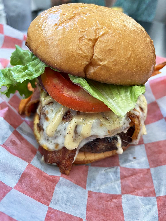 A burger so perfectly constructed it belongs in the Smithsonian. That melty cheese cascade is what food photographers dream about at night.
