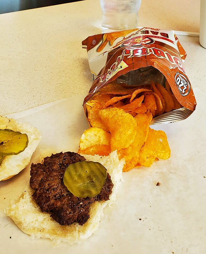 A burger with pickles alongside a bag of chips&mdash;proof that simplicity still reigns supreme. Some relationships are just meant to be.
