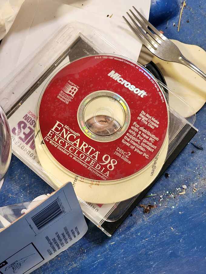 Technology time capsule alert! That Microsoft Encarta CD reminds us of a pre-Wikipedia era when knowledge came in shiny disc form.
