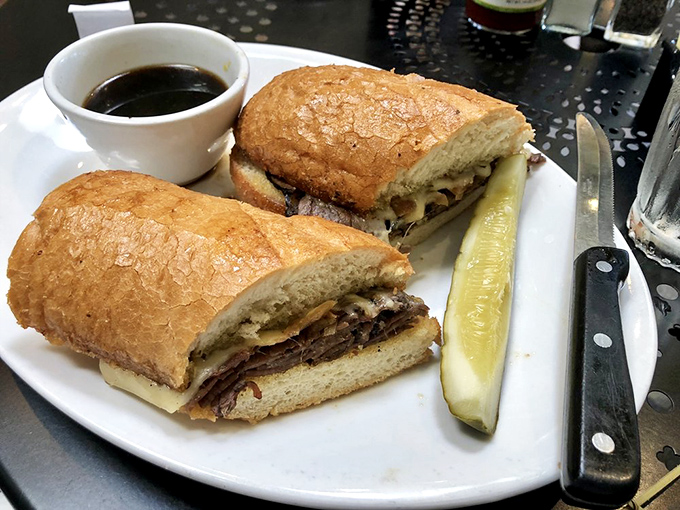 This isn't just a sandwich; it's architecture&mdash;sturdy bread supporting layers of savory goodness with a pickle standing guard.