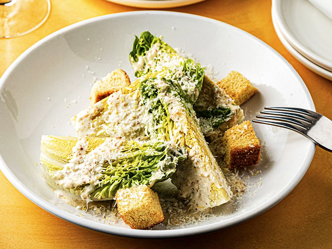 Even the Caesar salad gets the coastal treatment, with perfectly grilled romaine hearts standing at attention like they've just spotted a celebrity chef.