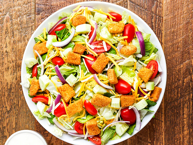 Even the side salad gets the star treatment&mdash;crisp greens, crunchy croutons, and shredded cheese create the perfect opening act for the main event.