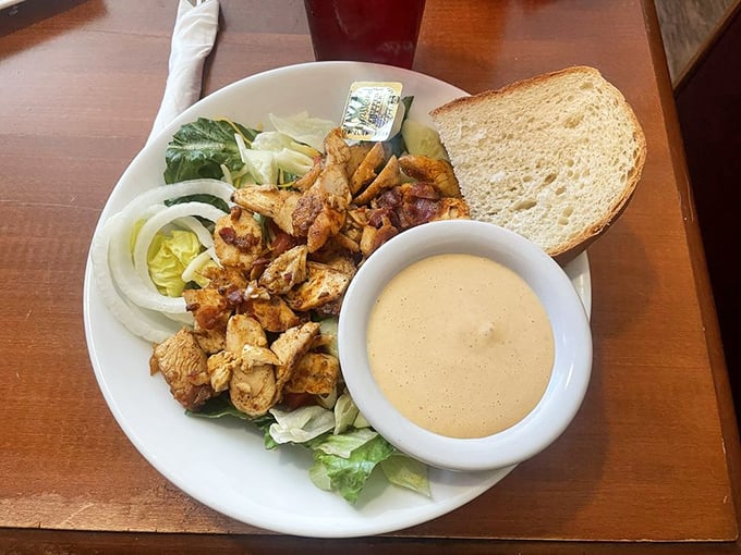 A chicken salad that actually makes eating healthy feel like cheating. That side of sauce isn't optional – it's the magic potion that ties everything together.