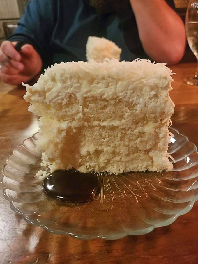 Coconut cake so fluffy and ethereal it makes clouds look dense by comparison—dessert nirvana achieved.
