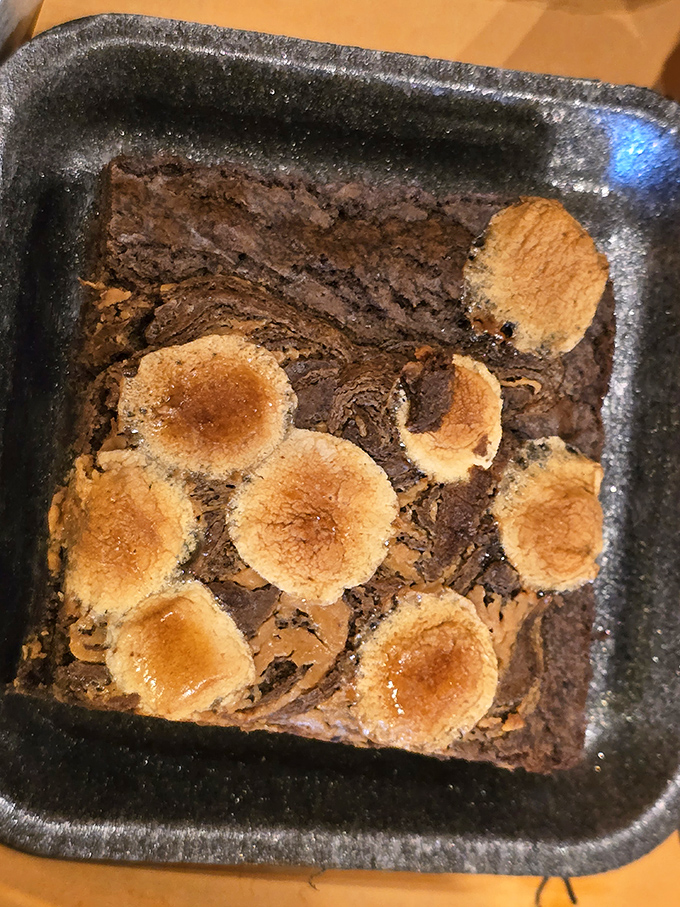 This isn't just a brownie—it's a chocolate campfire symphony with marshmallow high notes. Dessert that makes you want to sing around an imaginary fire.