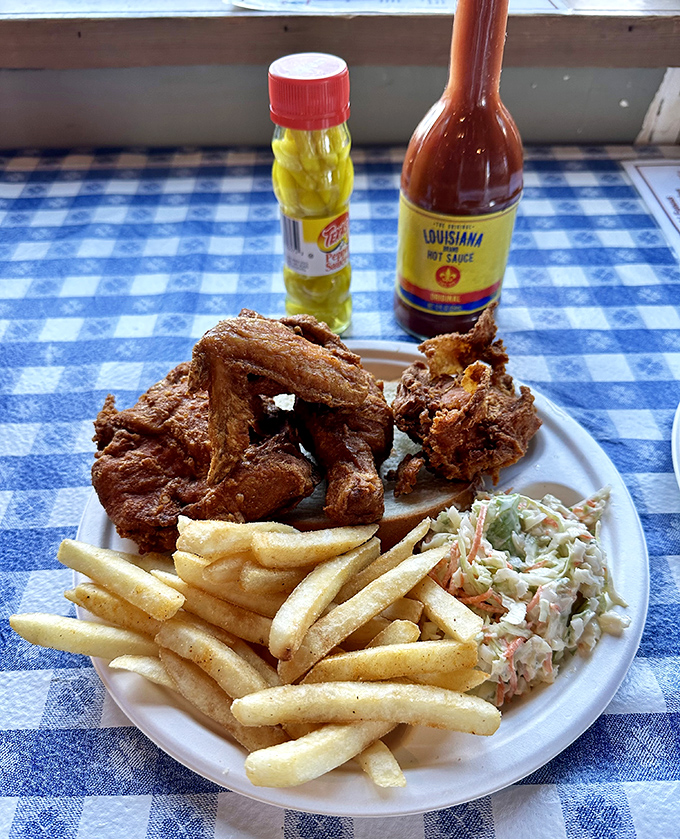 The holy trinity of Southern comfort: crispy wings, creamy coleslaw, and golden fries. Add hot sauce for religious experience.