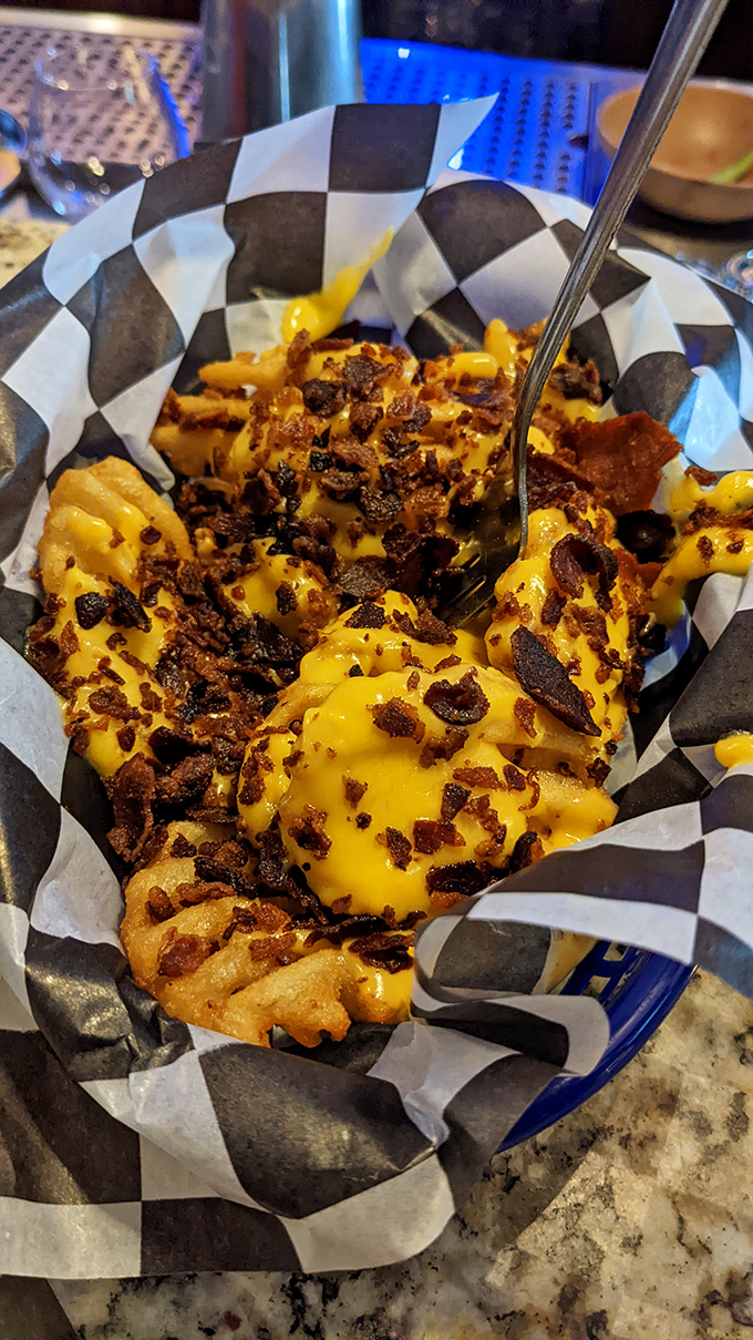 These aren't just cheese fries—they're a bacon-topped masterpiece that renders conversation impossible until the last bite.
