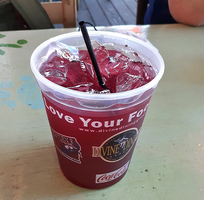 That ruby-red Southern elixir in a plastic cup &ndash; because sometimes the perfect accompaniment to seafood comes with free refills and nostalgic sweetness.