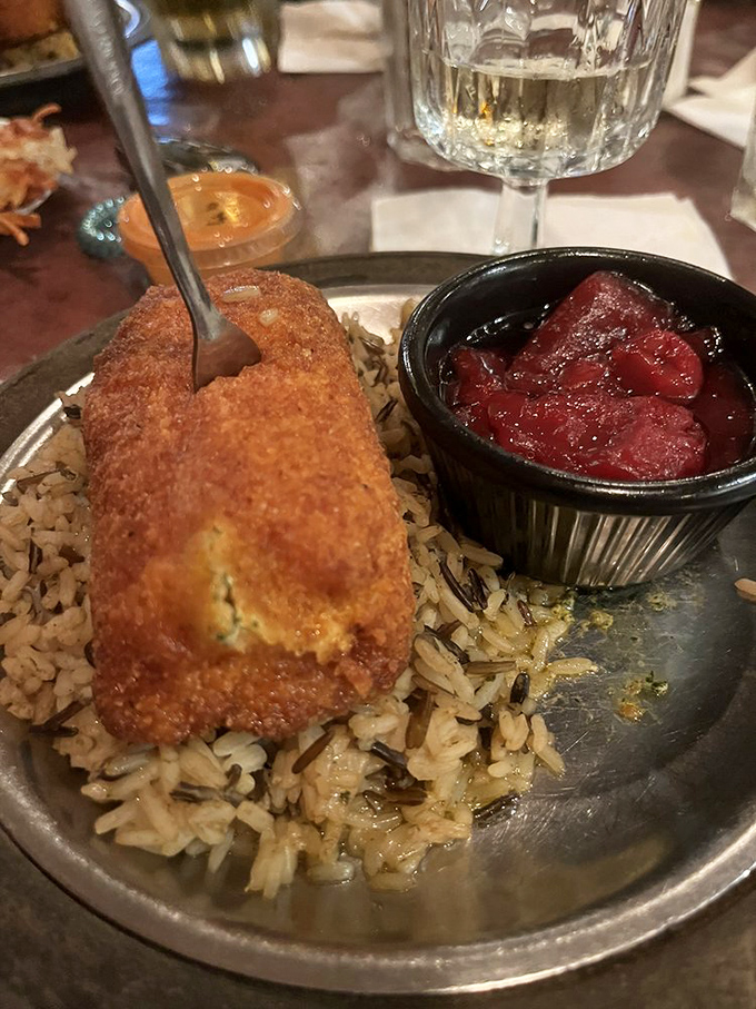 Crispy on the outside, bursting with buttery goodness inside&mdash;this chicken Kiev sits on a bed of wild rice like royalty on a throne.