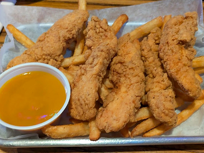 Chicken tenders that achieve the golden ratio of crispy exterior to juicy interior, with fries that don't know they're supposed to be sidekicks.