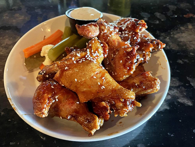 Wings that have been kissed by smoke before meeting their sticky-sweet glaze&mdash;a finger-licking affair worth every napkin.
