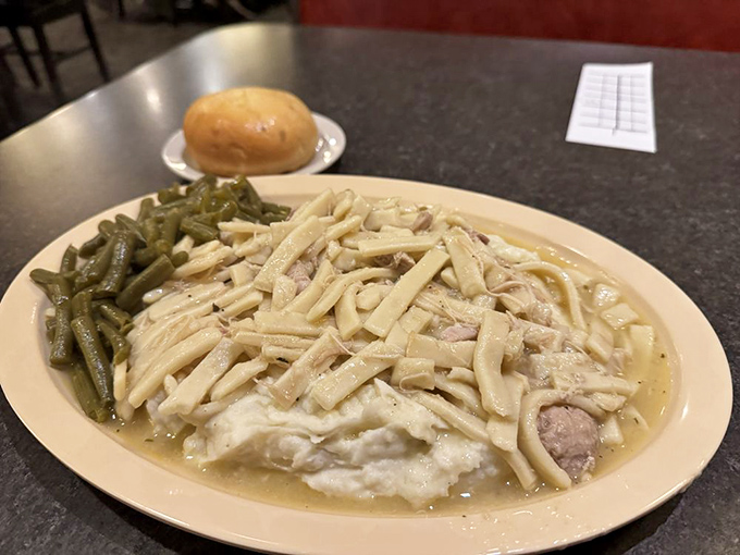 Chicken and noodles swimming in gravy with a side of green beans&mdash;the kind of plate that makes you want to call in sick tomorrow.